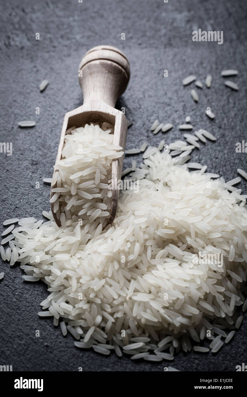 Wooden shovel and jasmine rice on slate Stock Photo - Alamy