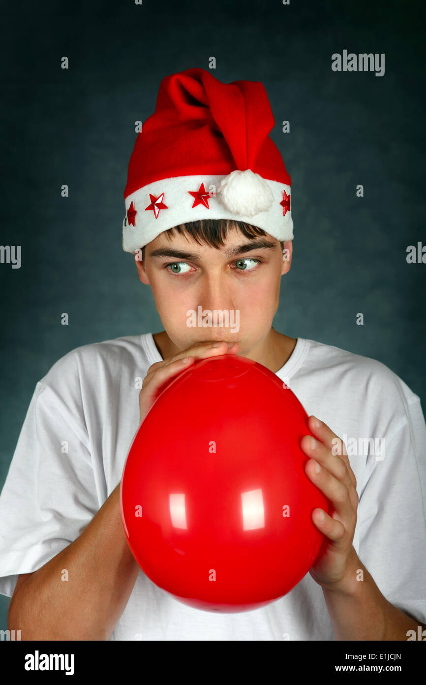 Boy blowing up red balloon hi-res stock photography and images - Alamy