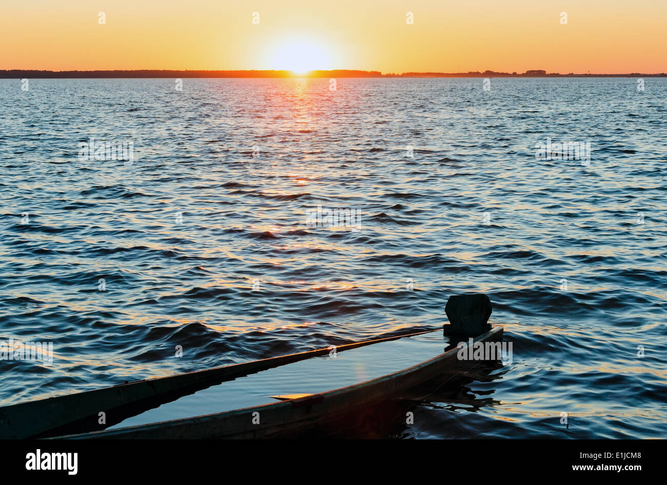 Sunset and drowned boat on summer lake bank Stock Photo - Alamy