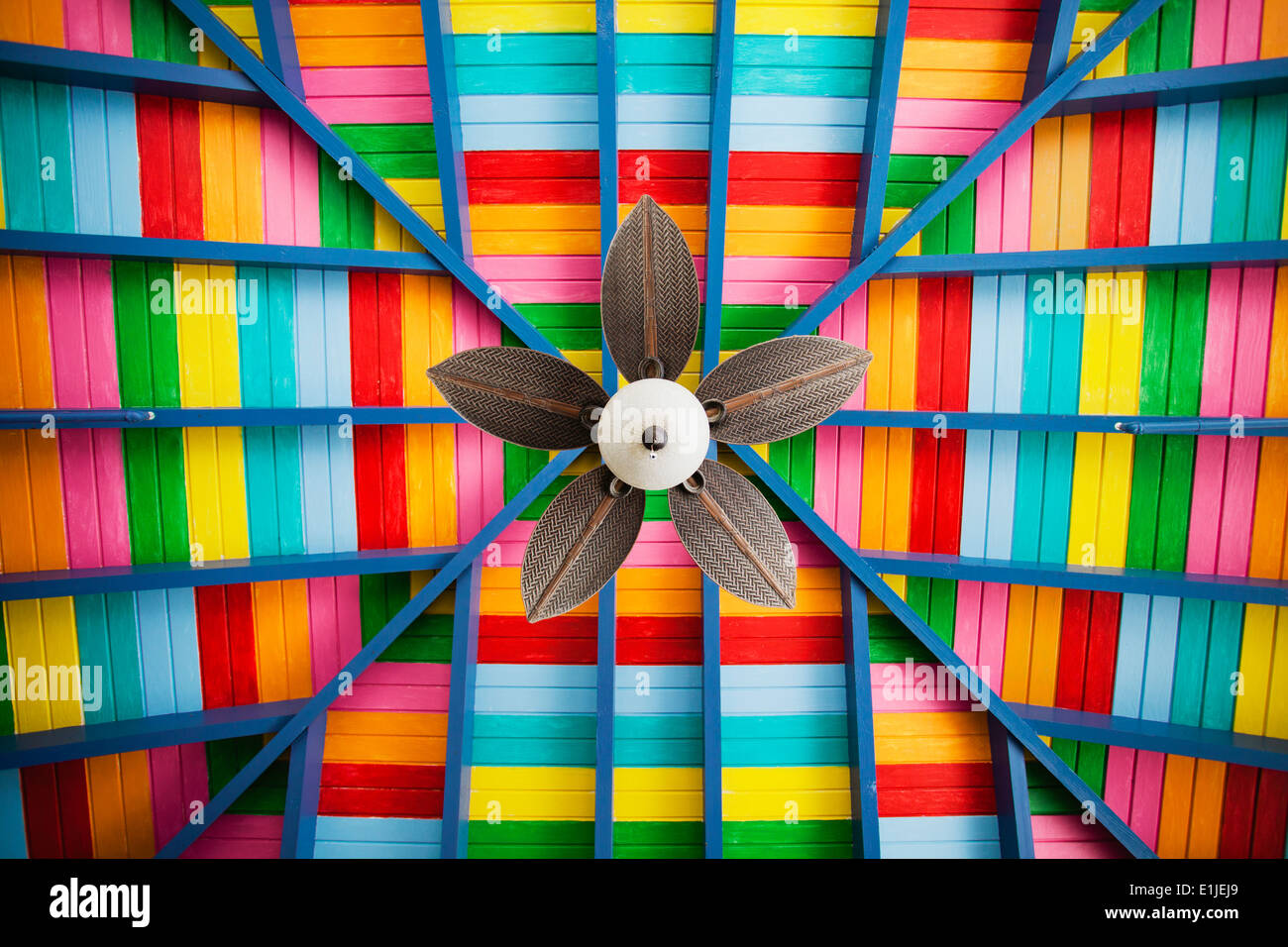 Petal-shaped fan on multi-coloured wooden ceiling Stock Photo - Alamy