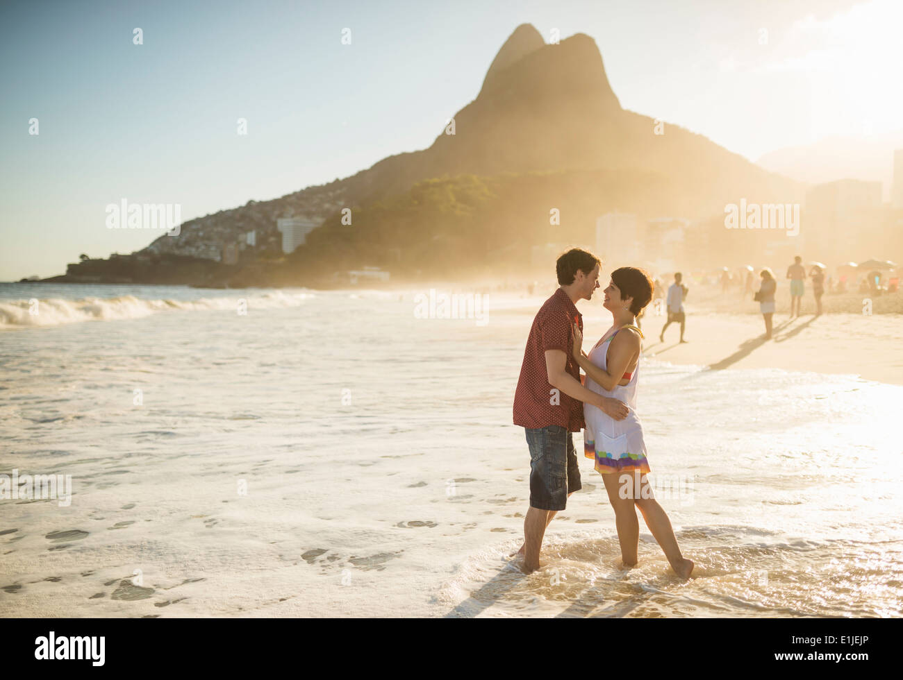 Young couple hugging sunset ipanema hi-res stock photography and images ...