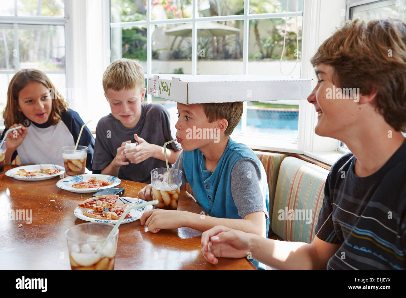 Boy balancing pizza box on hi-res stock photography and images - Alamy