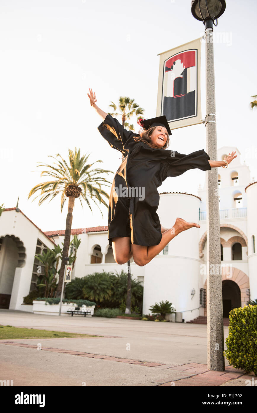 Female graduate jumping for joy Stock Photo - Alamy