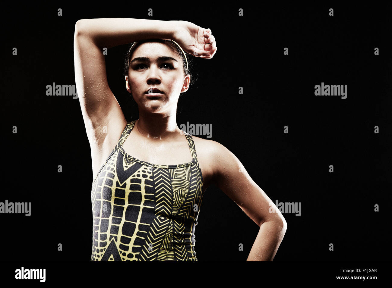 Young woman with arm on forehead Stock Photo - Alamy