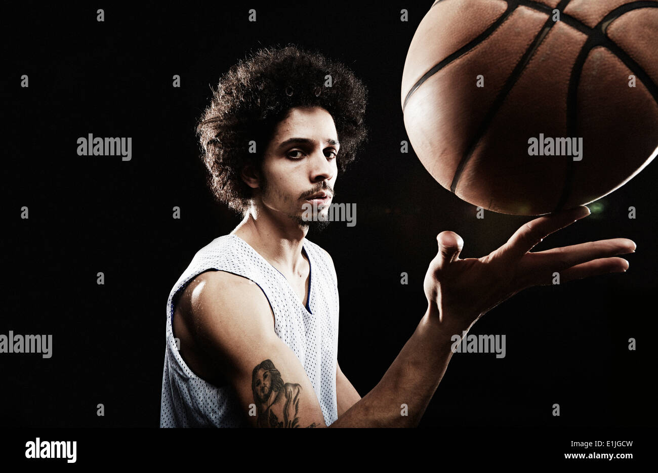 Basketball player balancing basketball on finger Stock Photo - Alamy