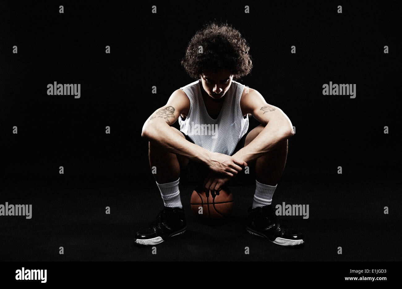 Portrait man sitting on basketball hi-res stock photography and images ...