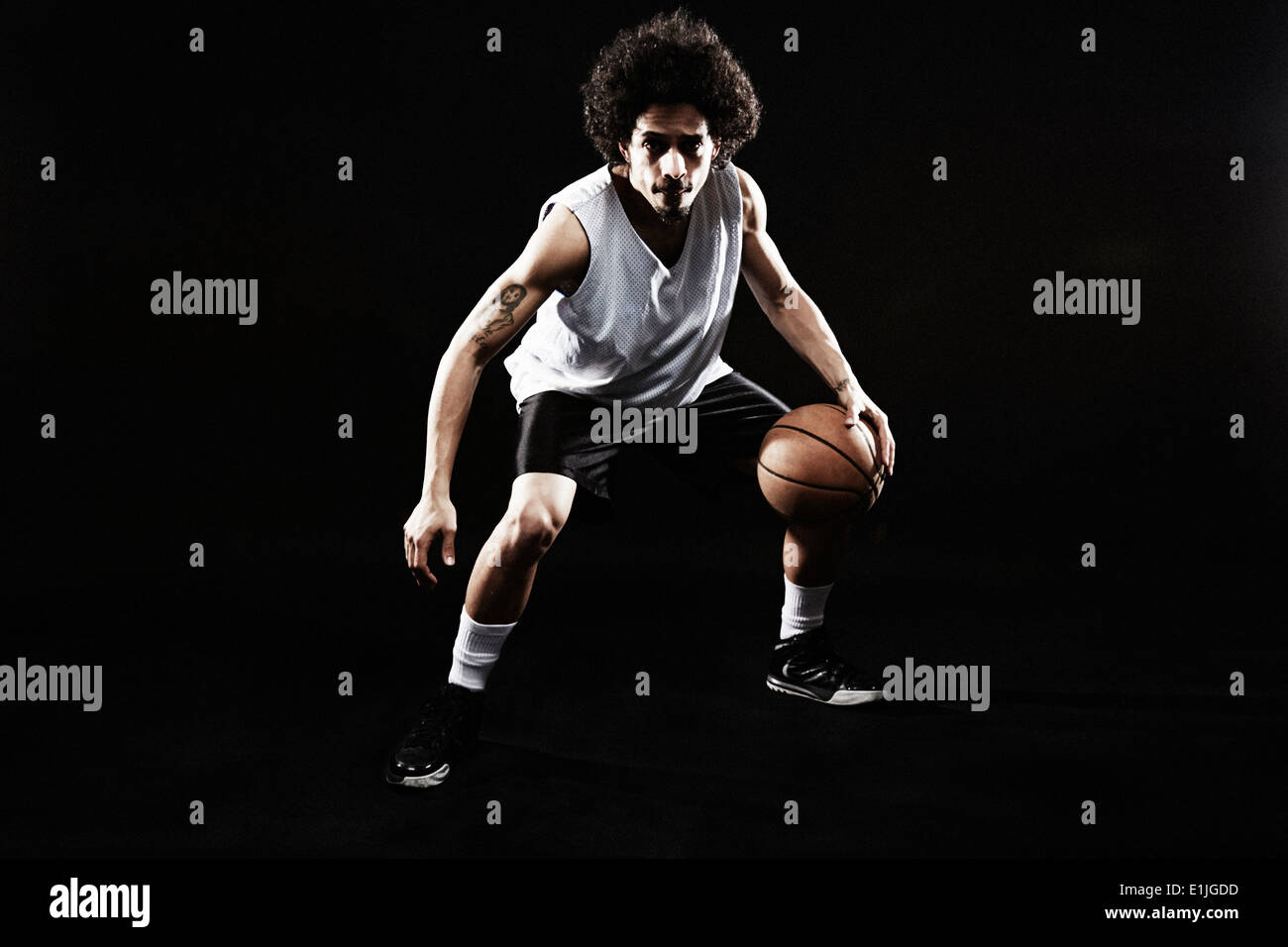 Young man bouncing basketball hi-res stock photography and images - Alamy
