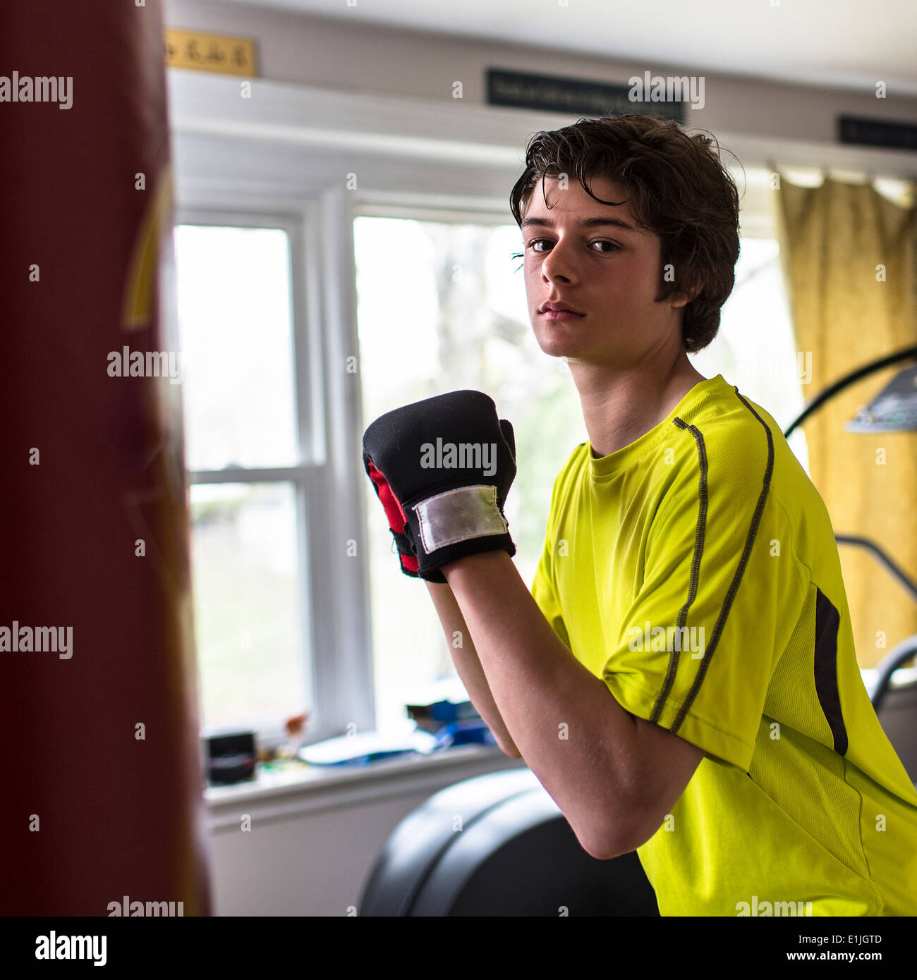 Teenage boy wearing boxing gloves Stock Photo - Alamy