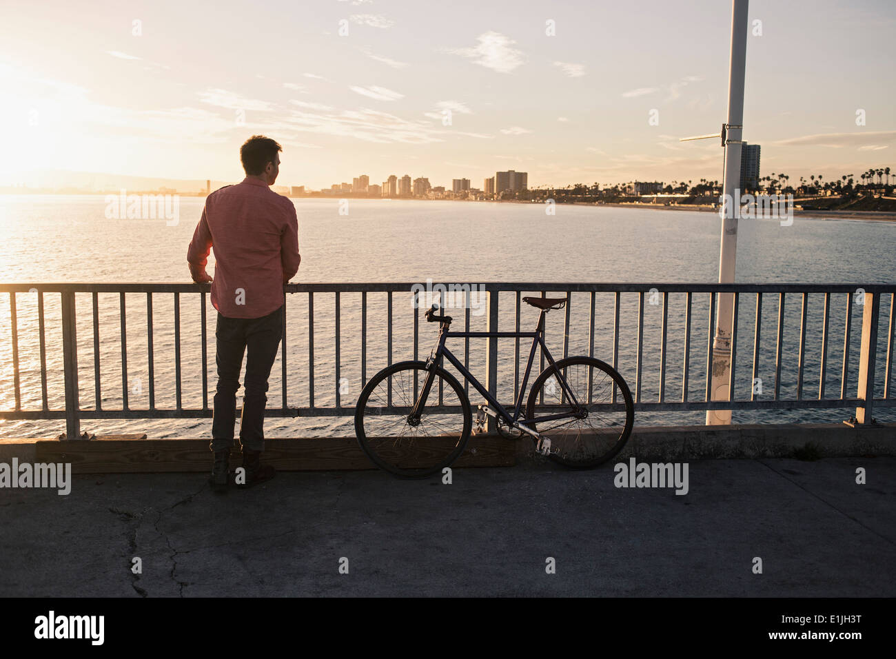 Young man gazing from pier hi-res stock photography and images - Alamy