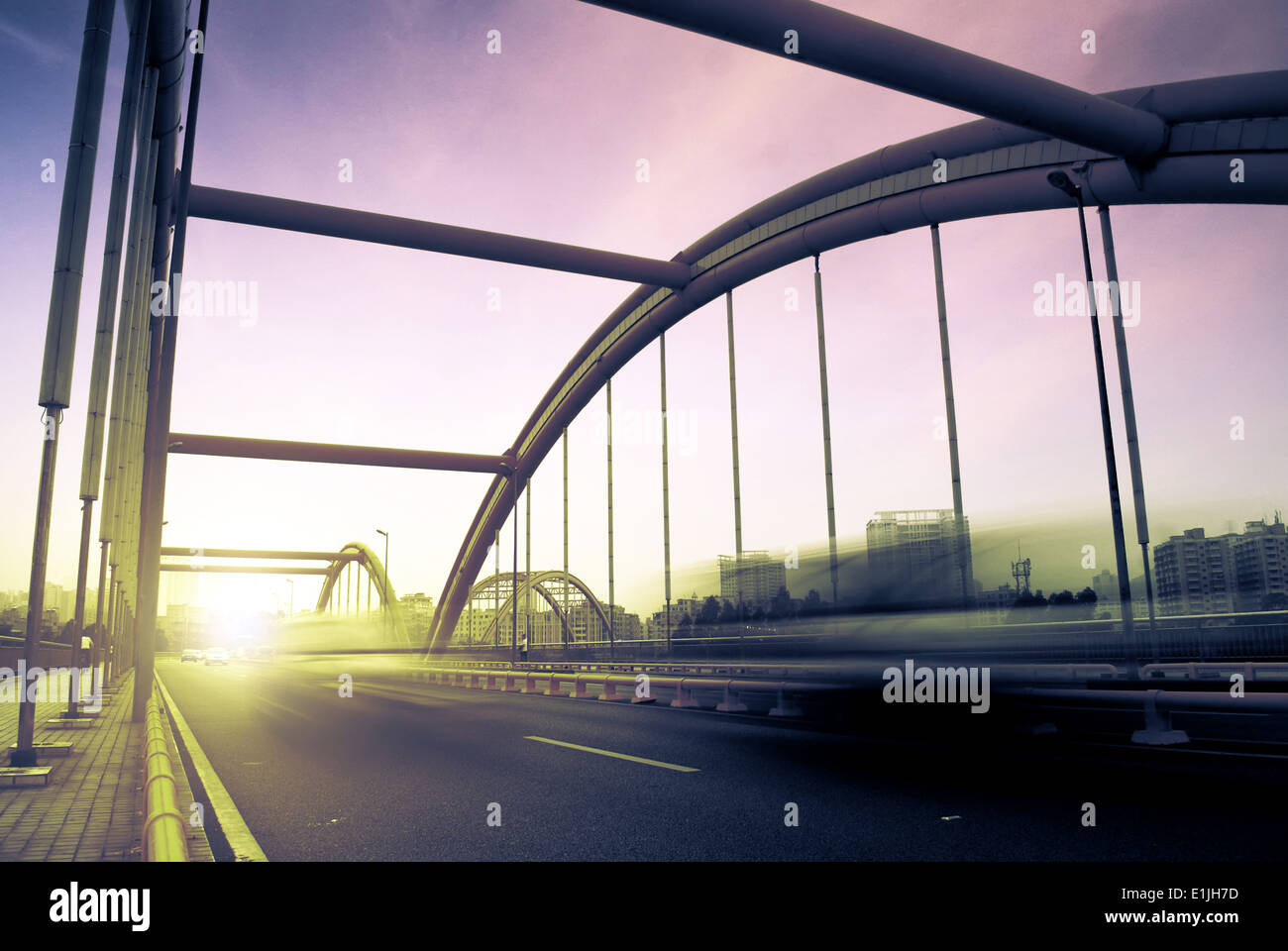 road through the bridge with blue sky background of a city Stock Photo ...