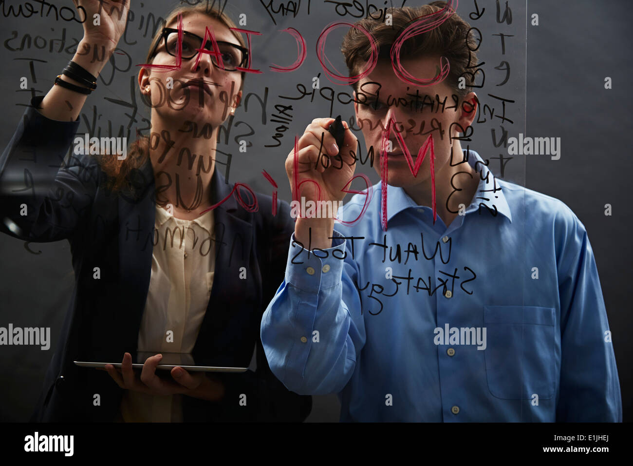 Business colleagues writing on glass Stock Photo - Alamy