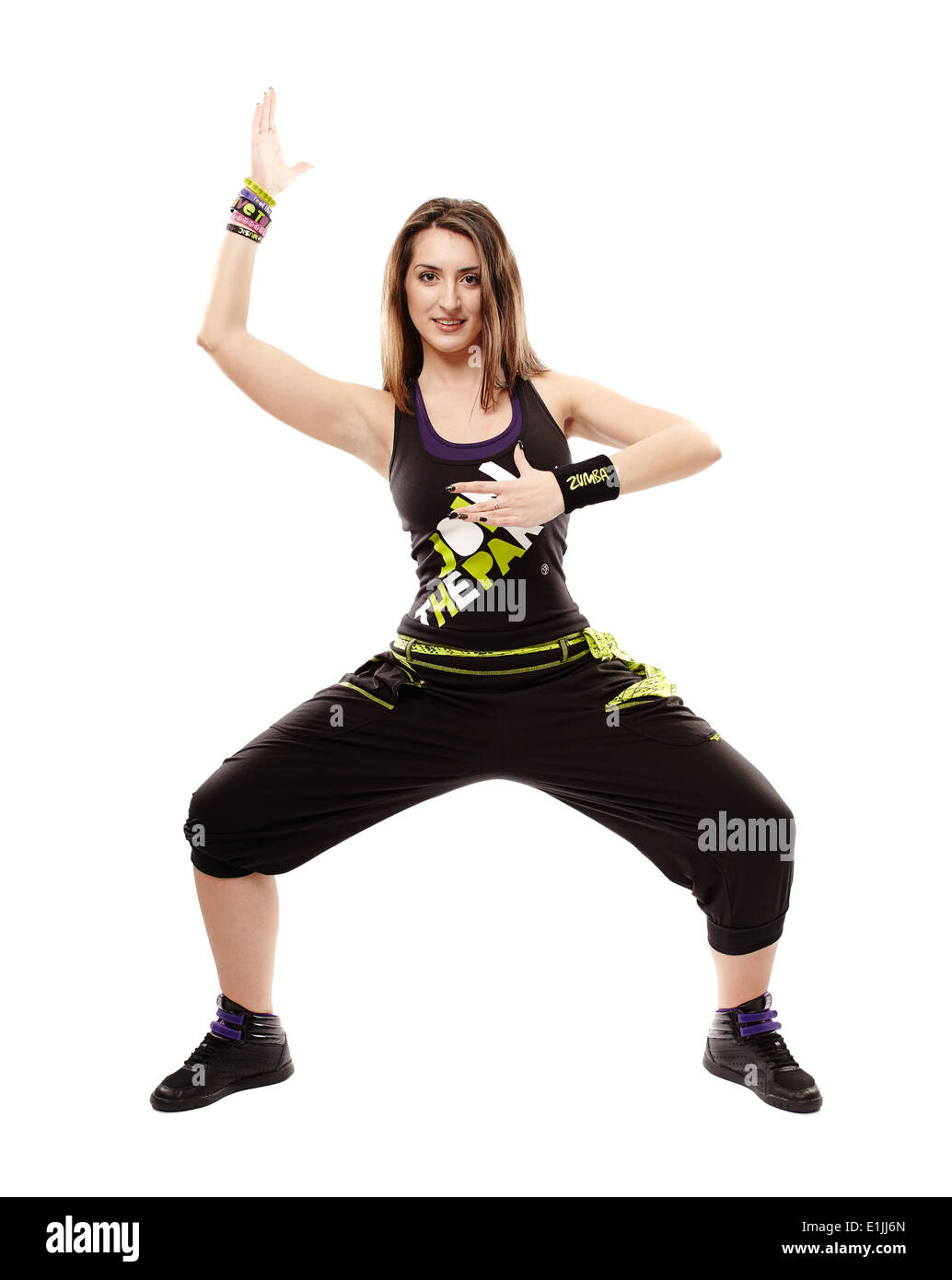Studio shot of young athletic woman doing zumba moves, isolated over ...