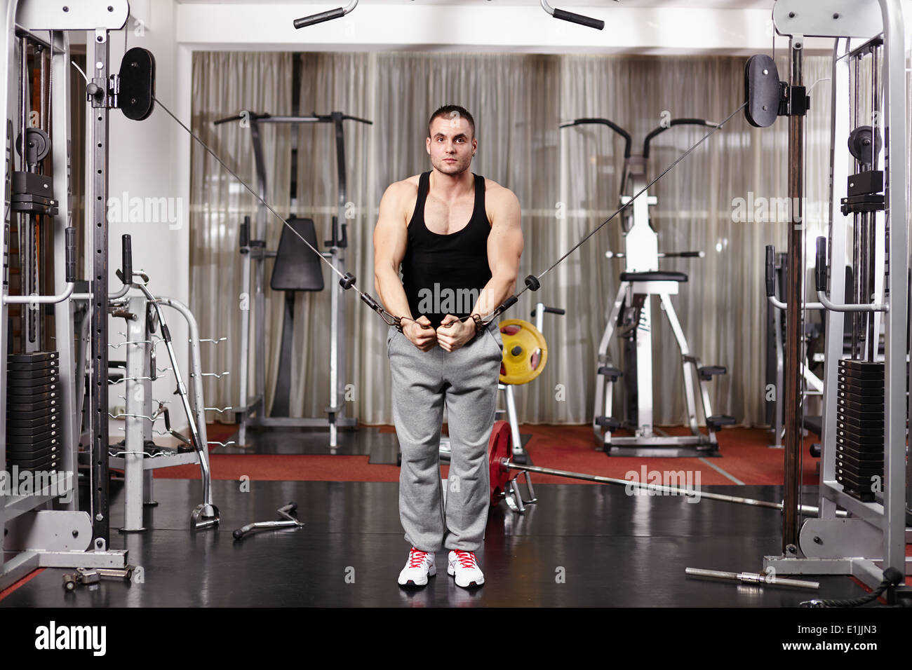 Young athletic man pulling heavy weights at the gym Stock Photo - Alamy