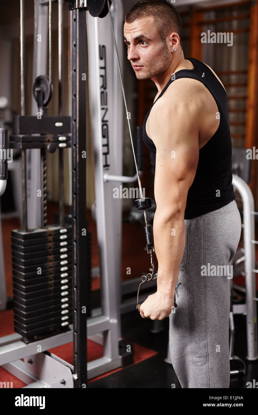 Young athletic man pulling heavy weights at the gym Stock Photo - Alamy