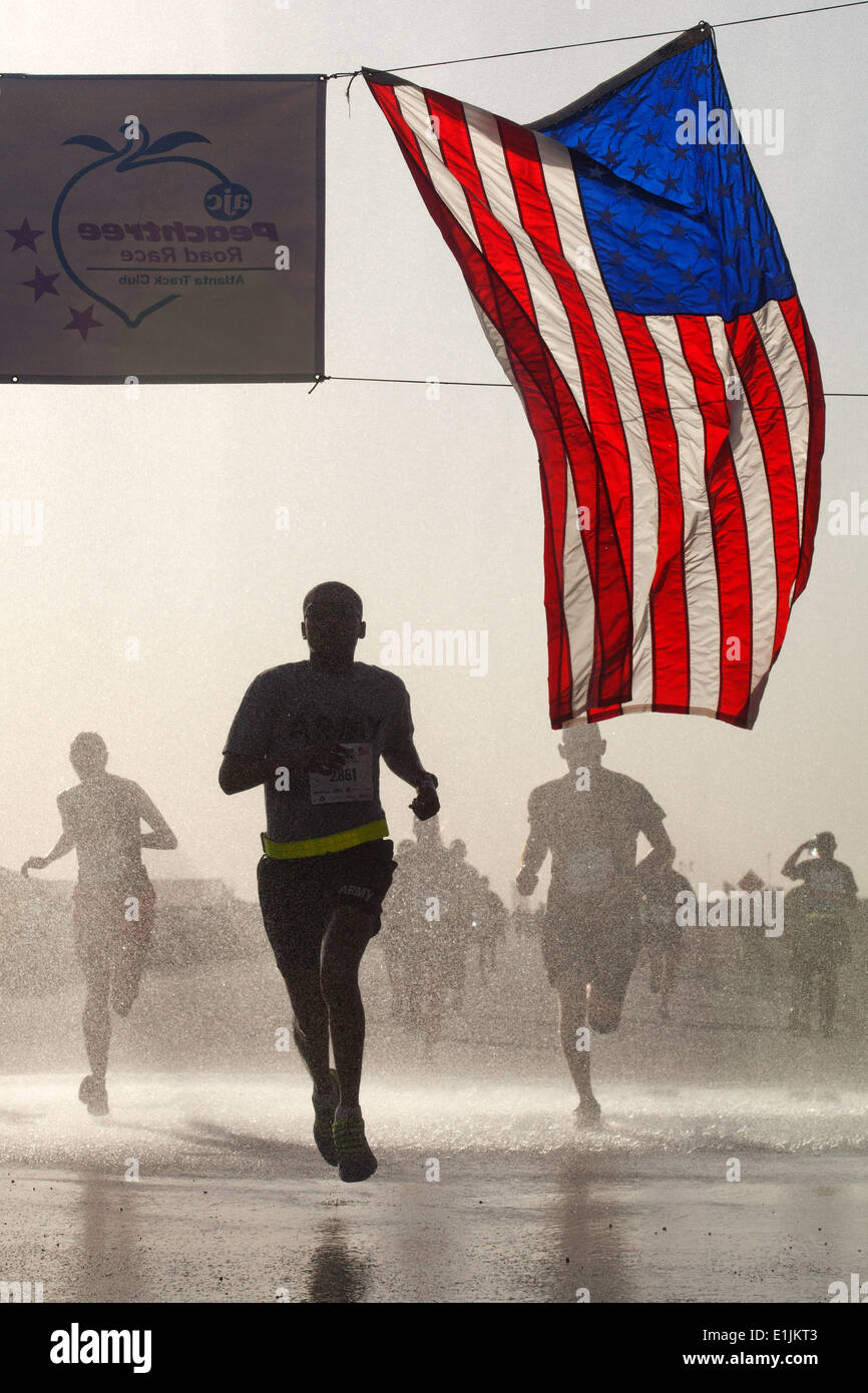 A U.S. Soldier crosses the finish line during a satellite version of ...