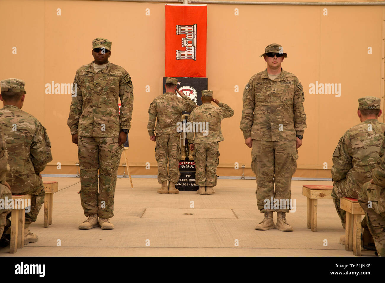U.S. Soldiers, center, salute during a memorial service at Shindand Air ...