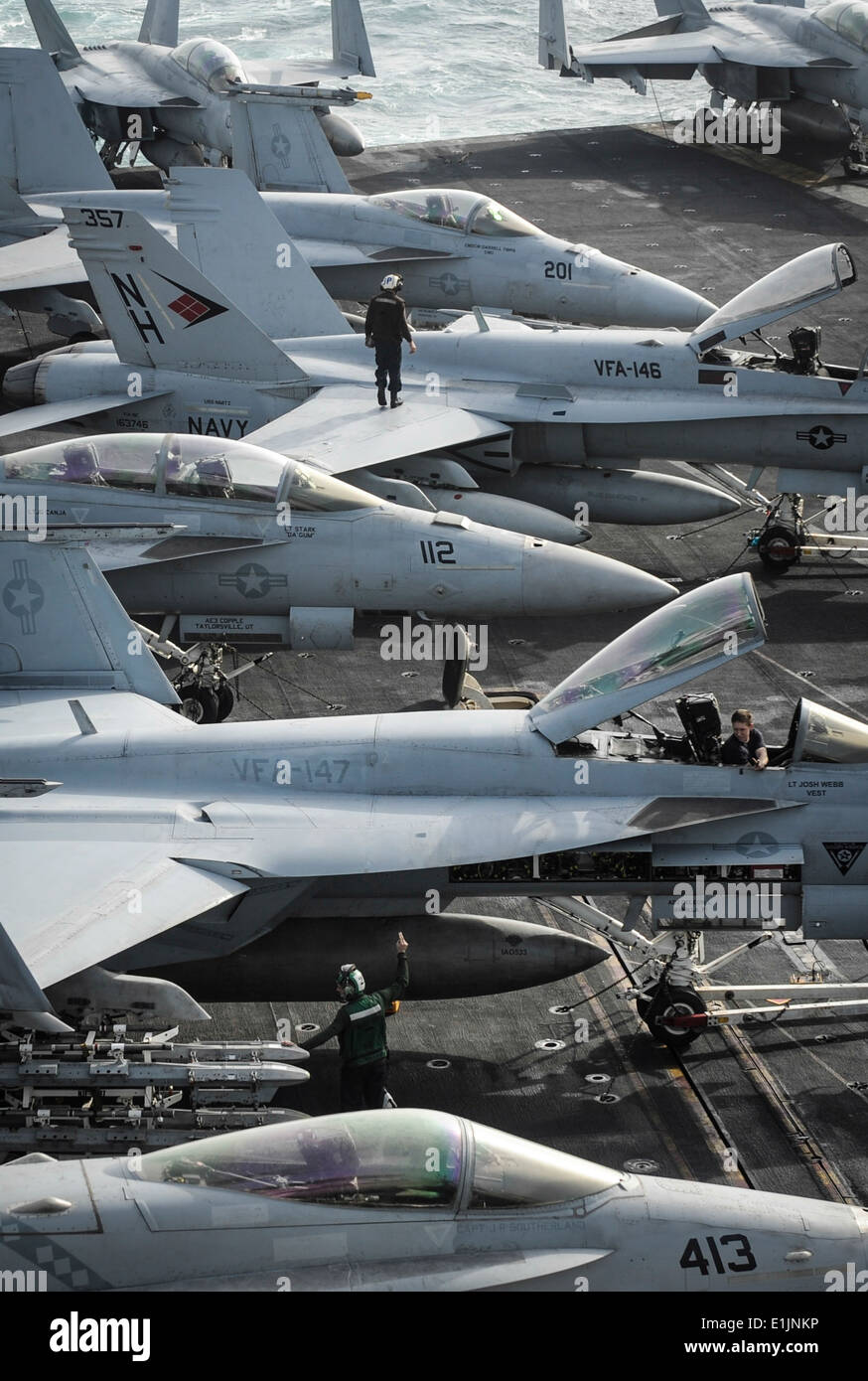 U.S. Sailors prepare aircraft for flight operations on the flight deck ...
