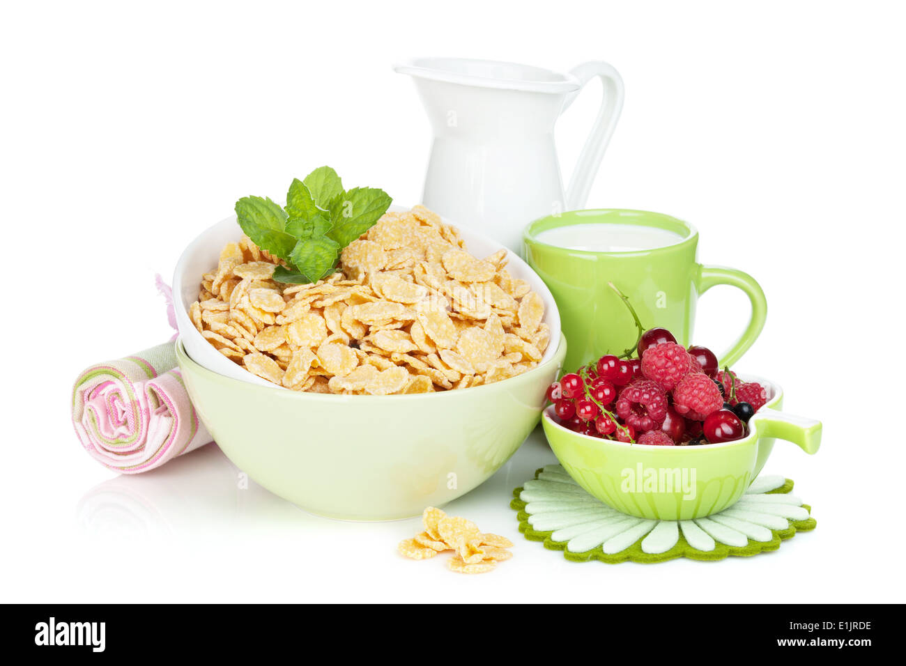 Fresh corn flakes with berries and milk. Isolated on white background ...