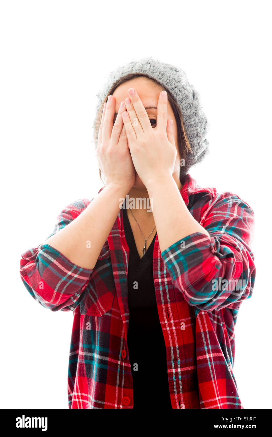Young woman peeking through hands covering face Stock Photo - Alamy