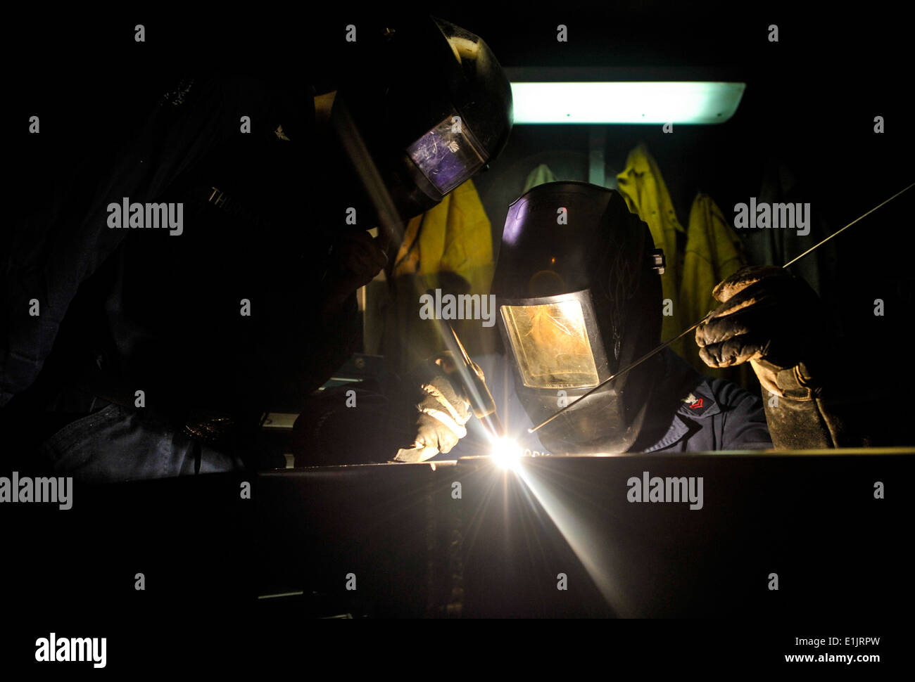 U.S. Navy Hull Maintenance Technician 2nd Class Neil Hopkins, right ...