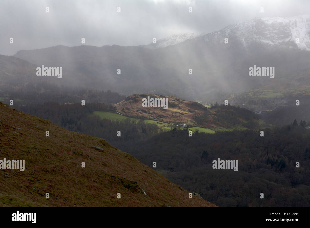 Storm clouds and snow over Wetherlam and The Old Man of Coniston from ...