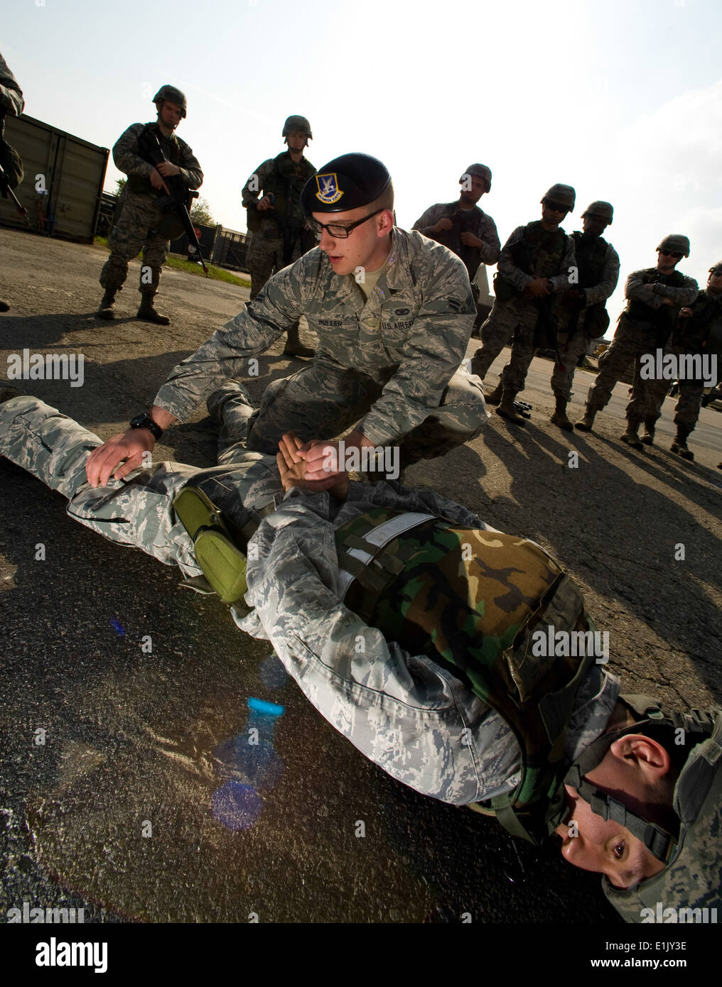 U.S. Air Force Airman 1st Class Zane Muller, kneeling, an instructor ...