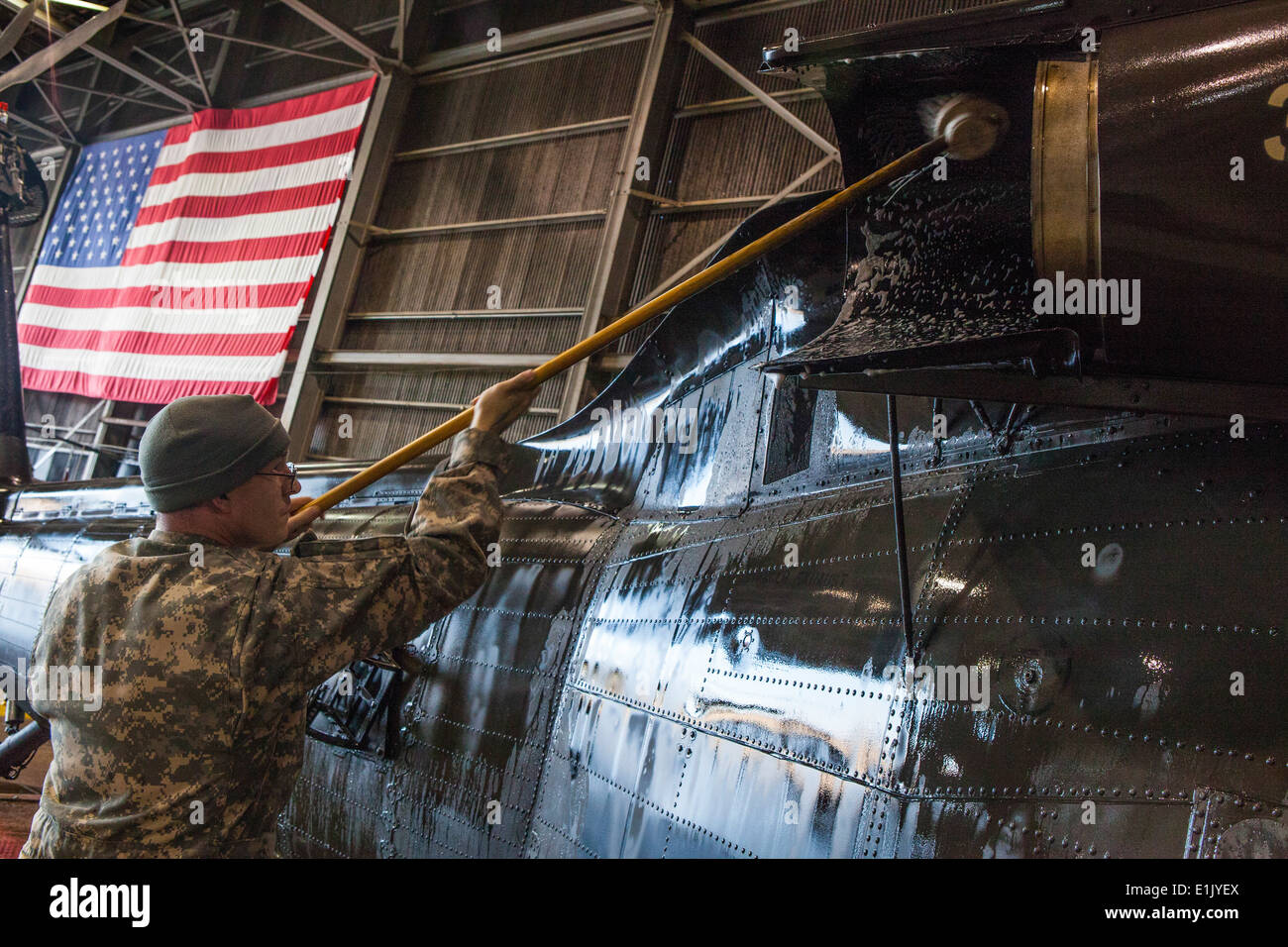 U.S. Army Sgt. Timothy A. Witts washes a UH-60 Black Hawk helicopter ...