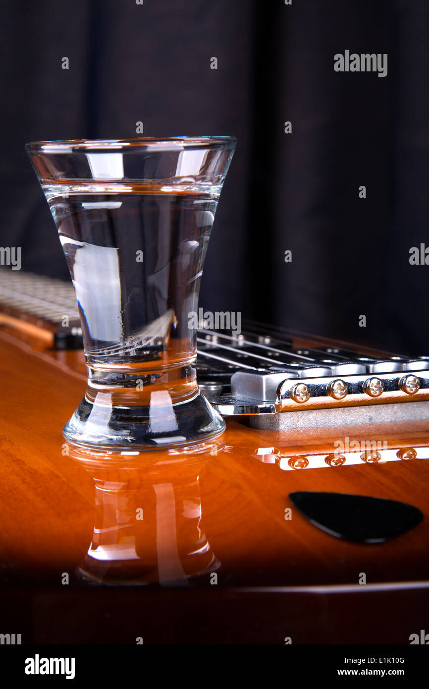 Glass of tequila on the electric guitar Stock Photo - Alamy