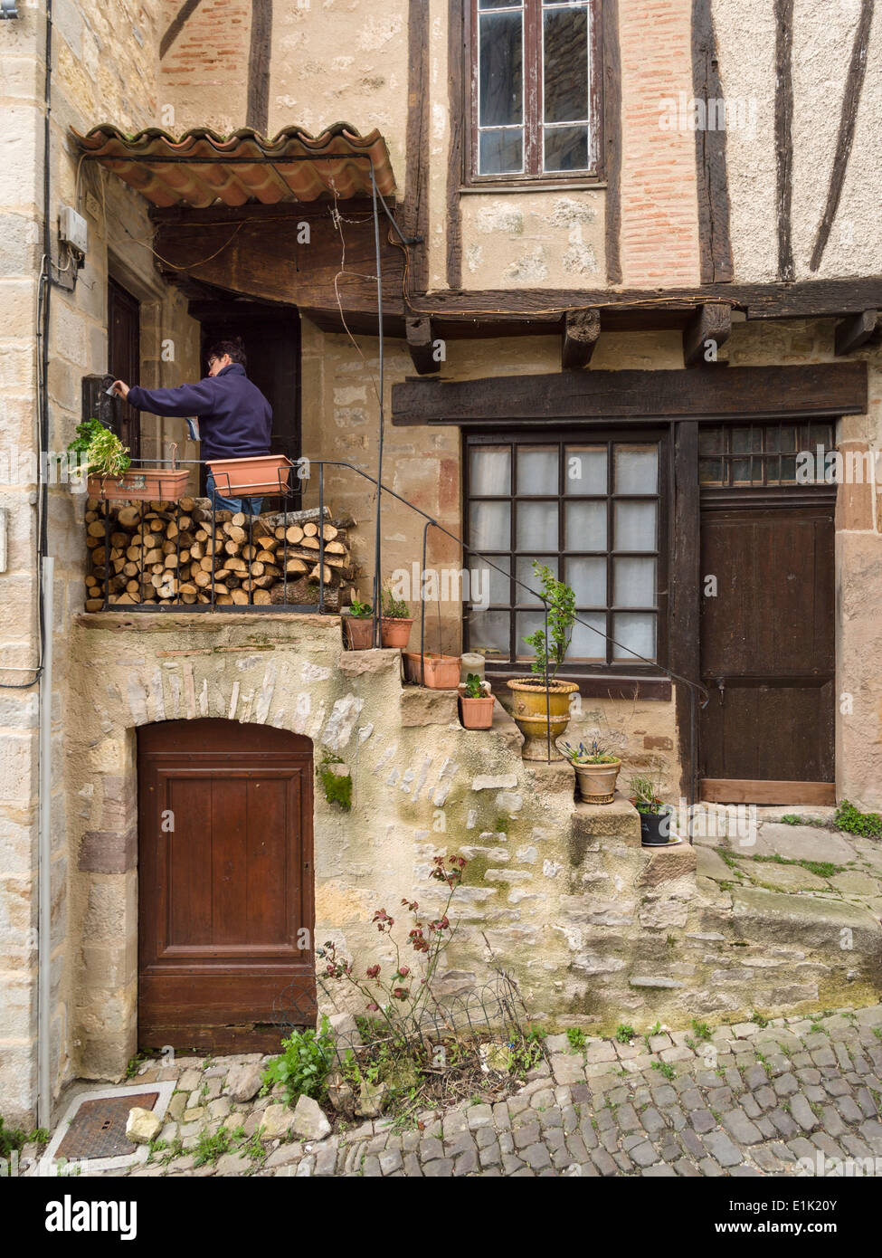 Postal Delivery. A delivery person places mail in a mailbox of a ...