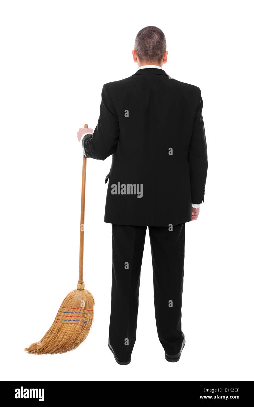 Businessman with a broom is cleaning the ground Stock Photo - Alamy