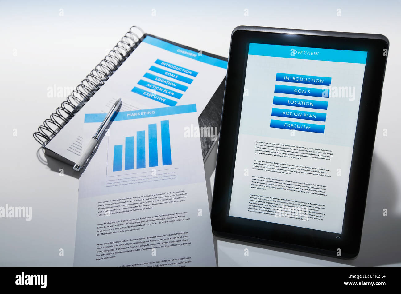 Business Plan presentation displayed on tablet and printed document ...
