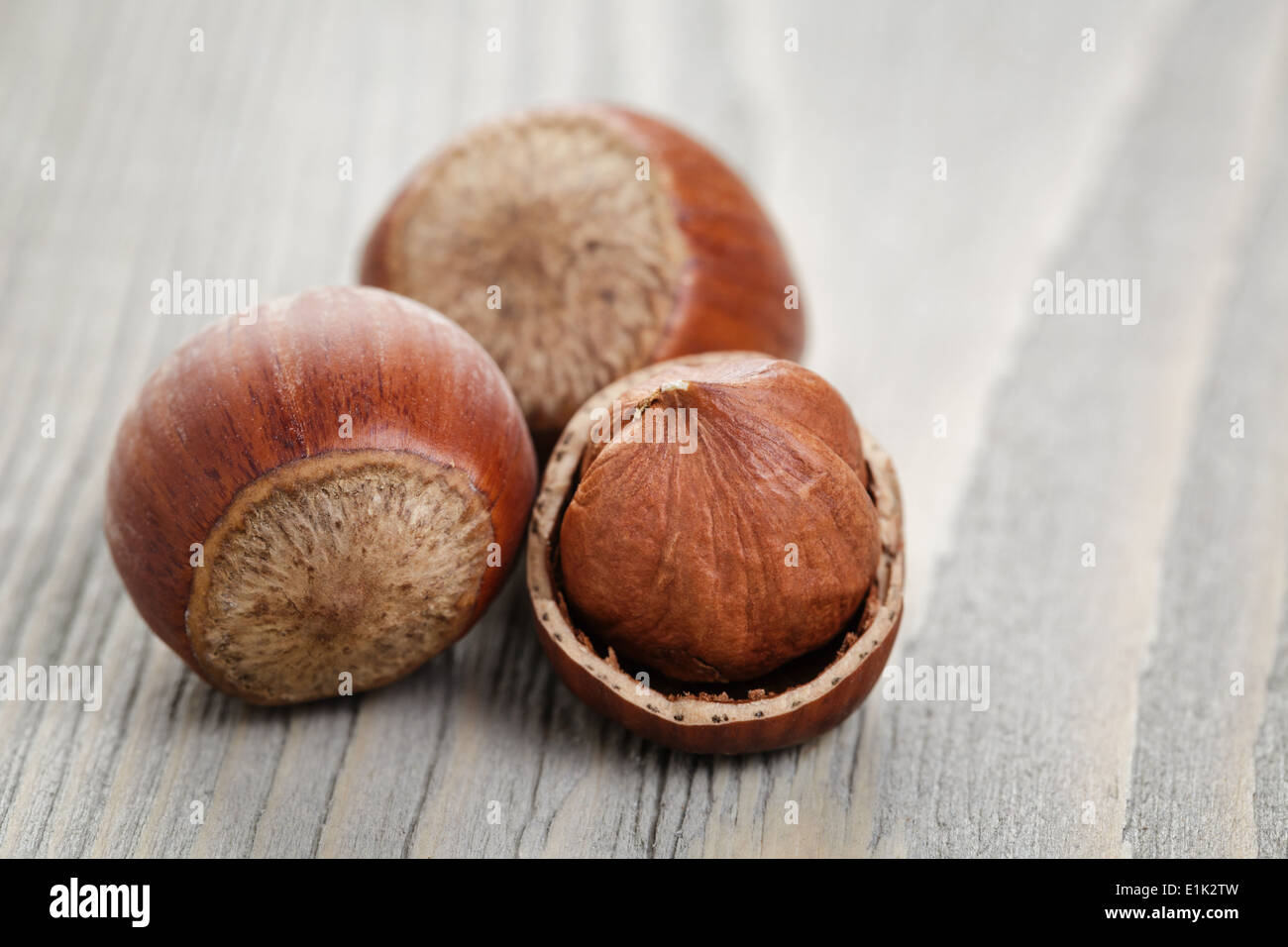 close up open and whole hazelnuts on wood table Stock Photo - Alamy