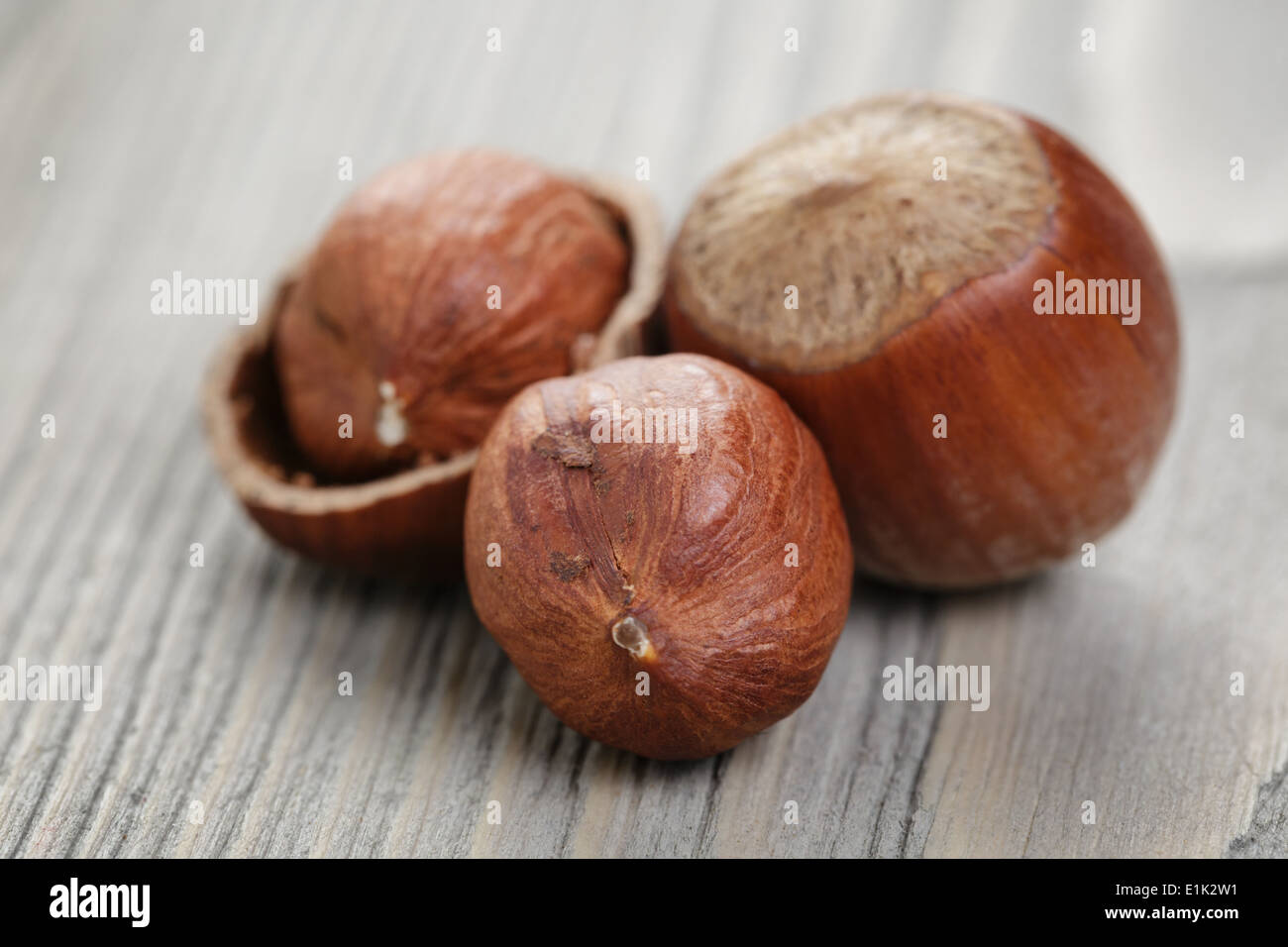 close up open and whole hazelnuts on wood table Stock Photo - Alamy