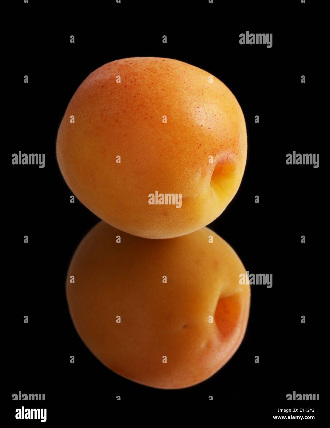 single ripe apricot, isolated on black background Stock Photo - Alamy