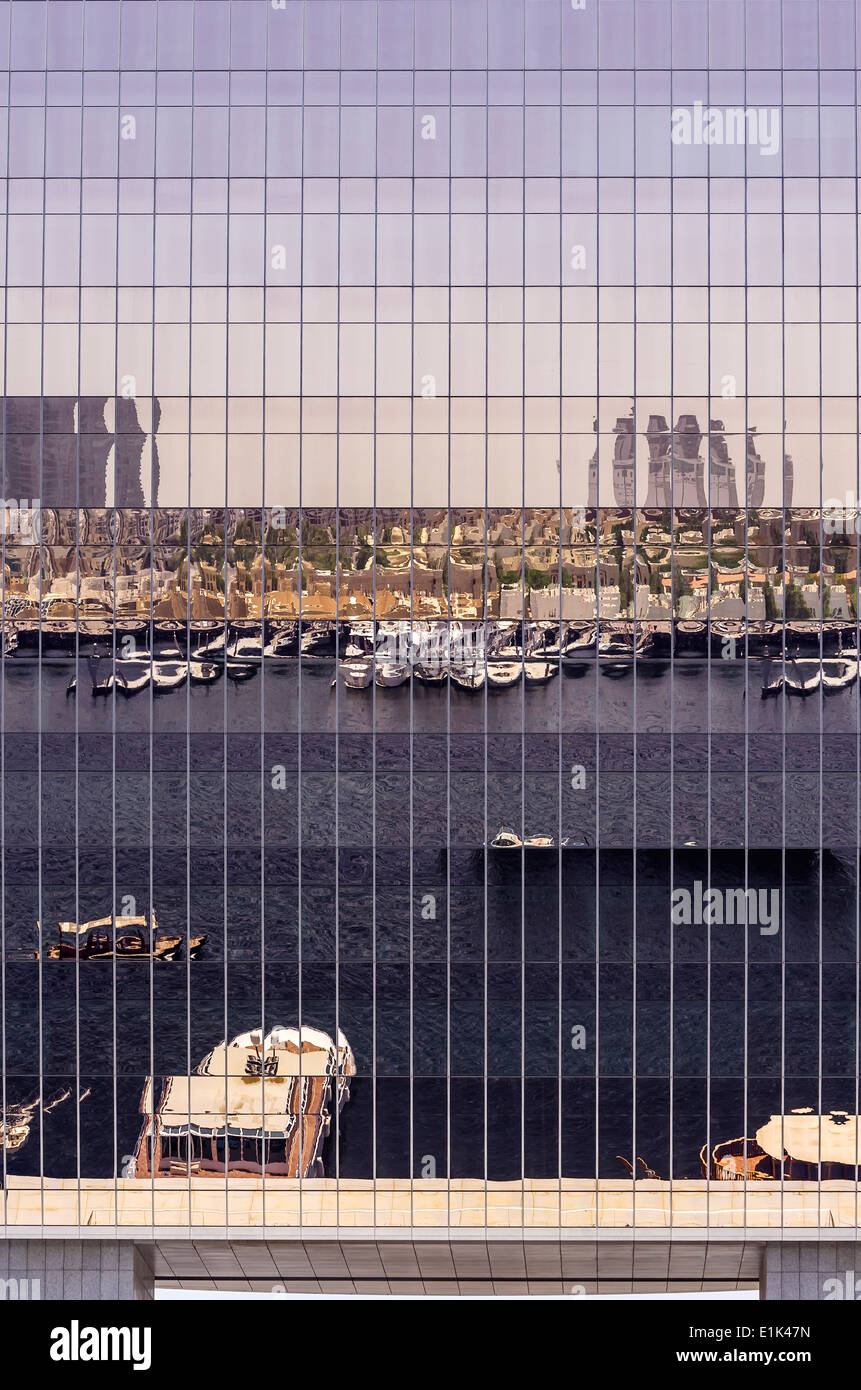 UAE, Dubai, Bur Dubai, Reflections in glass front of highrise building ...