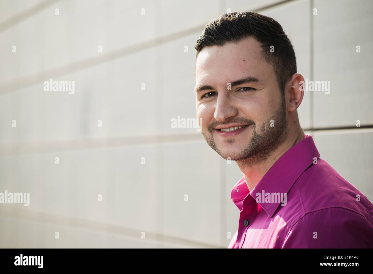 Portrait of smiling man wearing pink shirt Stock Photo - Alamy