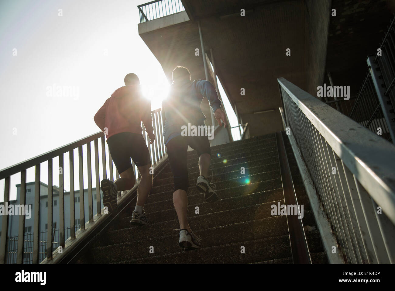 Young man and teenager tower running Stock Photo - Alamy