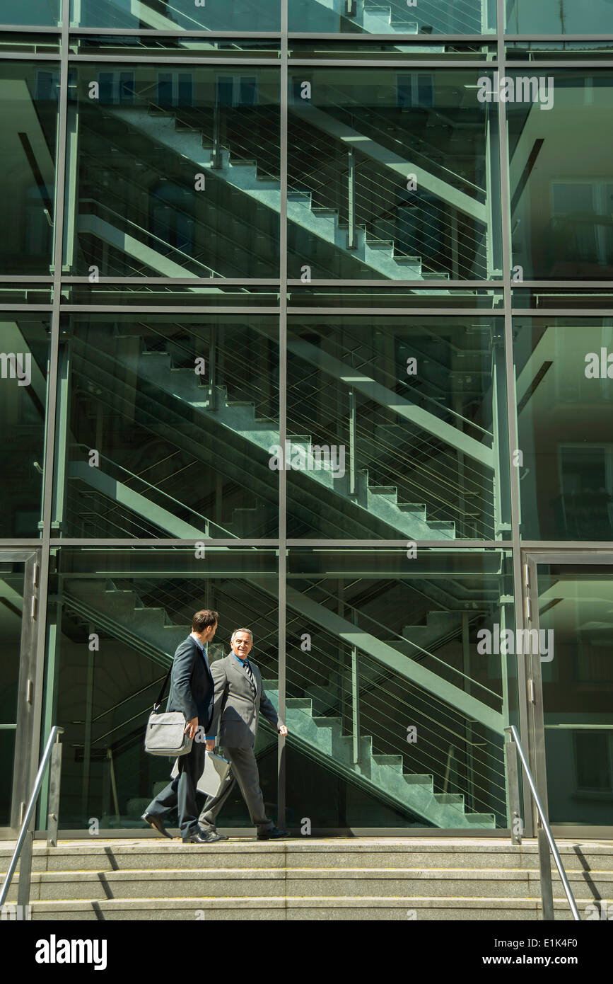 Two businessmen talking outside office building Stock Photo - Alamy