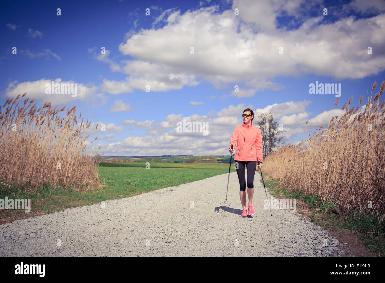 Female Nordic walker on the move through the rural landscape Stock ...