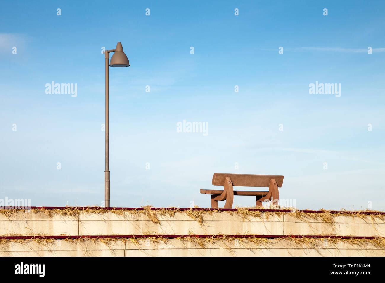 Germany, Lower Saxony, Dornum, wooden bench at waterfront promenade ...
