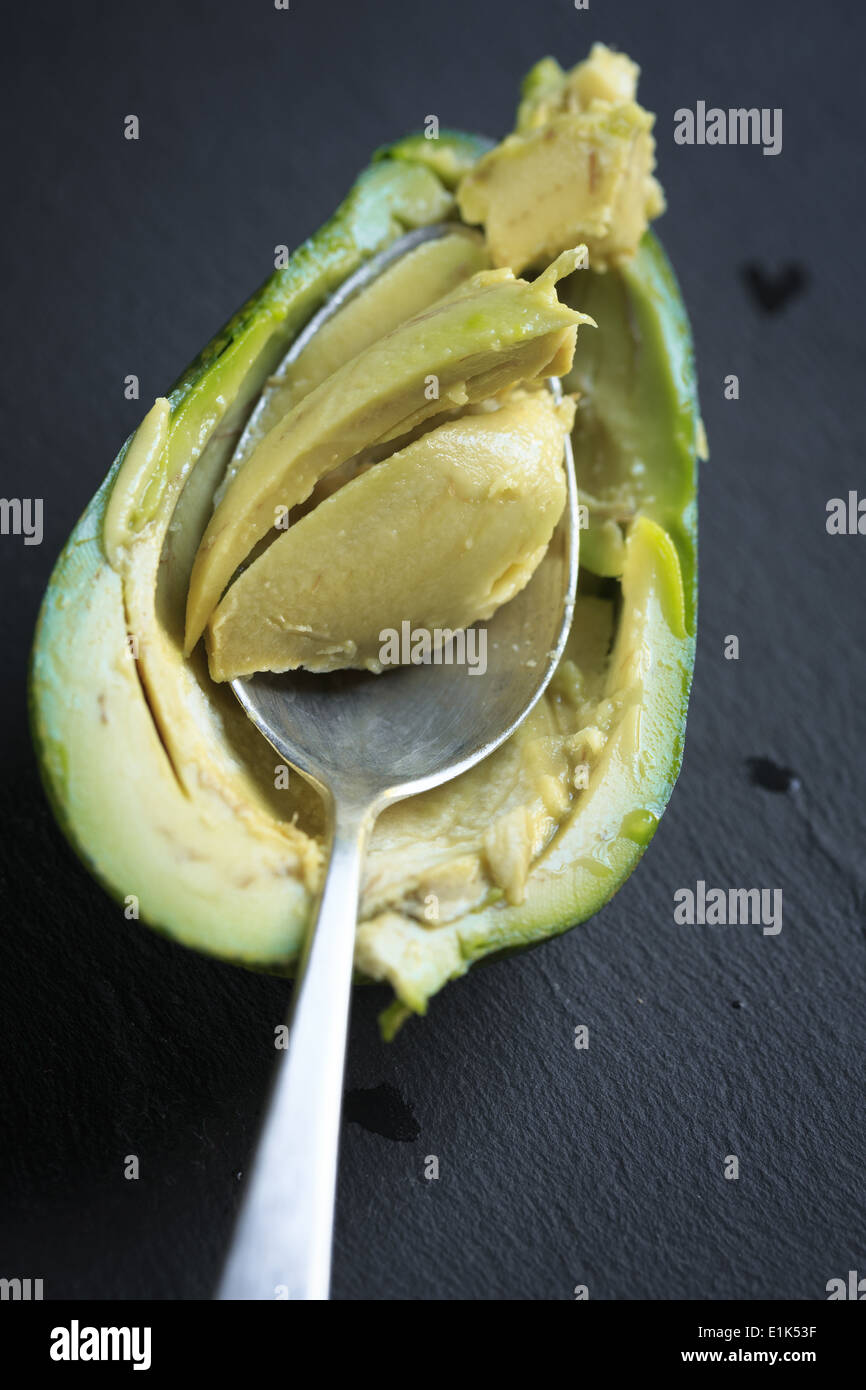 Avocado with a silver Spoon Stock Photo - Alamy