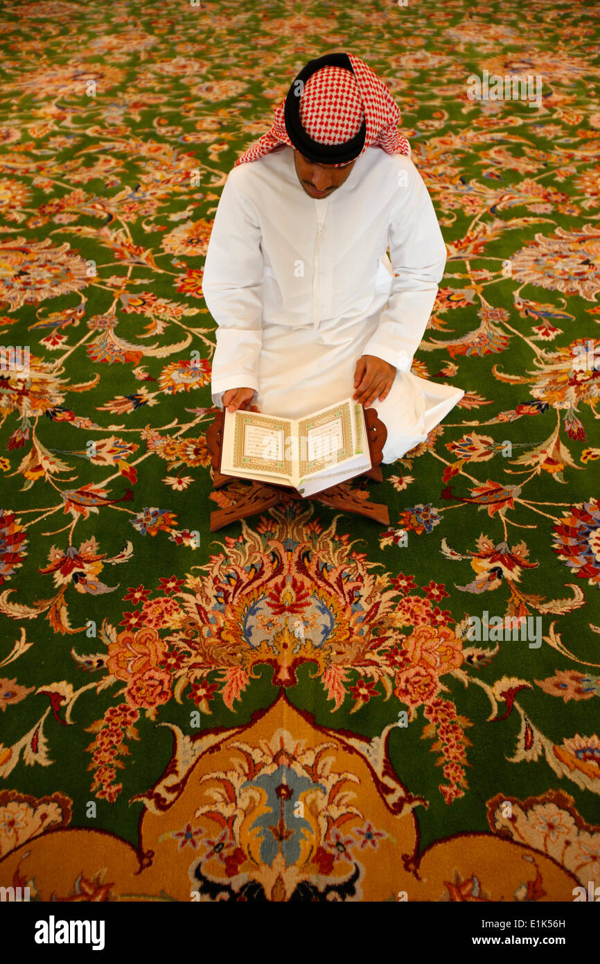 Sheikh Zayed Grand Mosque. Muslim man reading the koran Stock Photo - Alamy