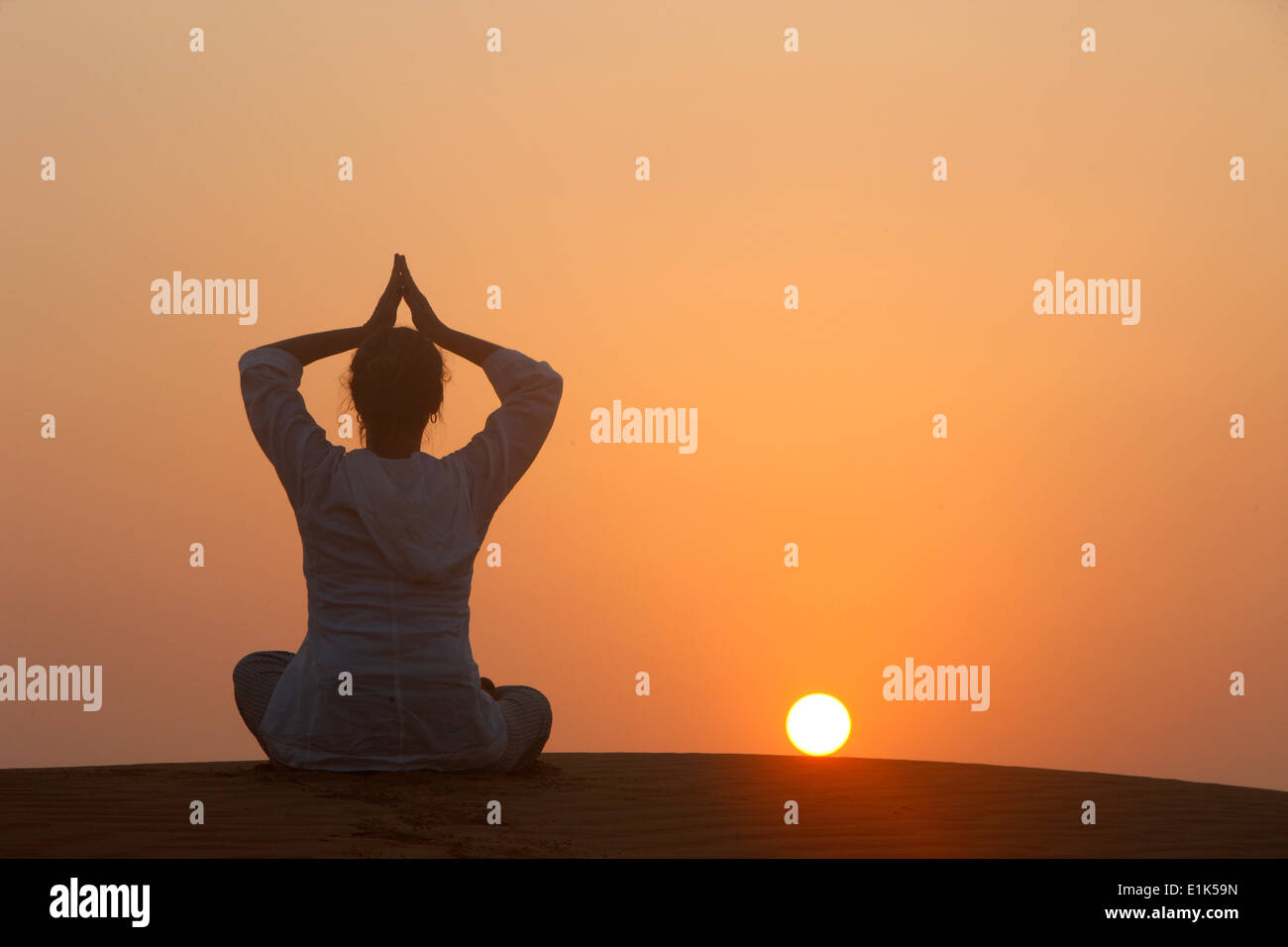 Sunset meditation in the desert Stock Photo - Alamy