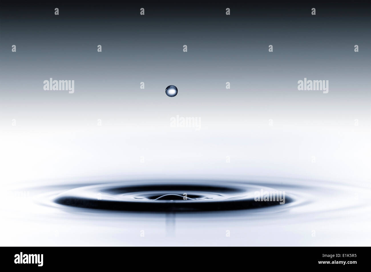 Water droplet against a grey background Stock Photo - Alamy
