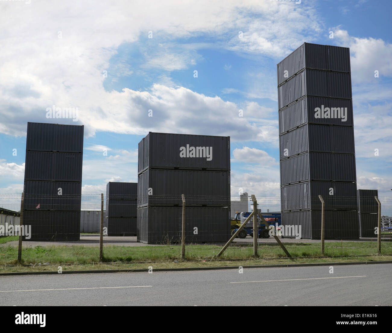 Shipping containers in industrial compound Stock Photo - Alamy