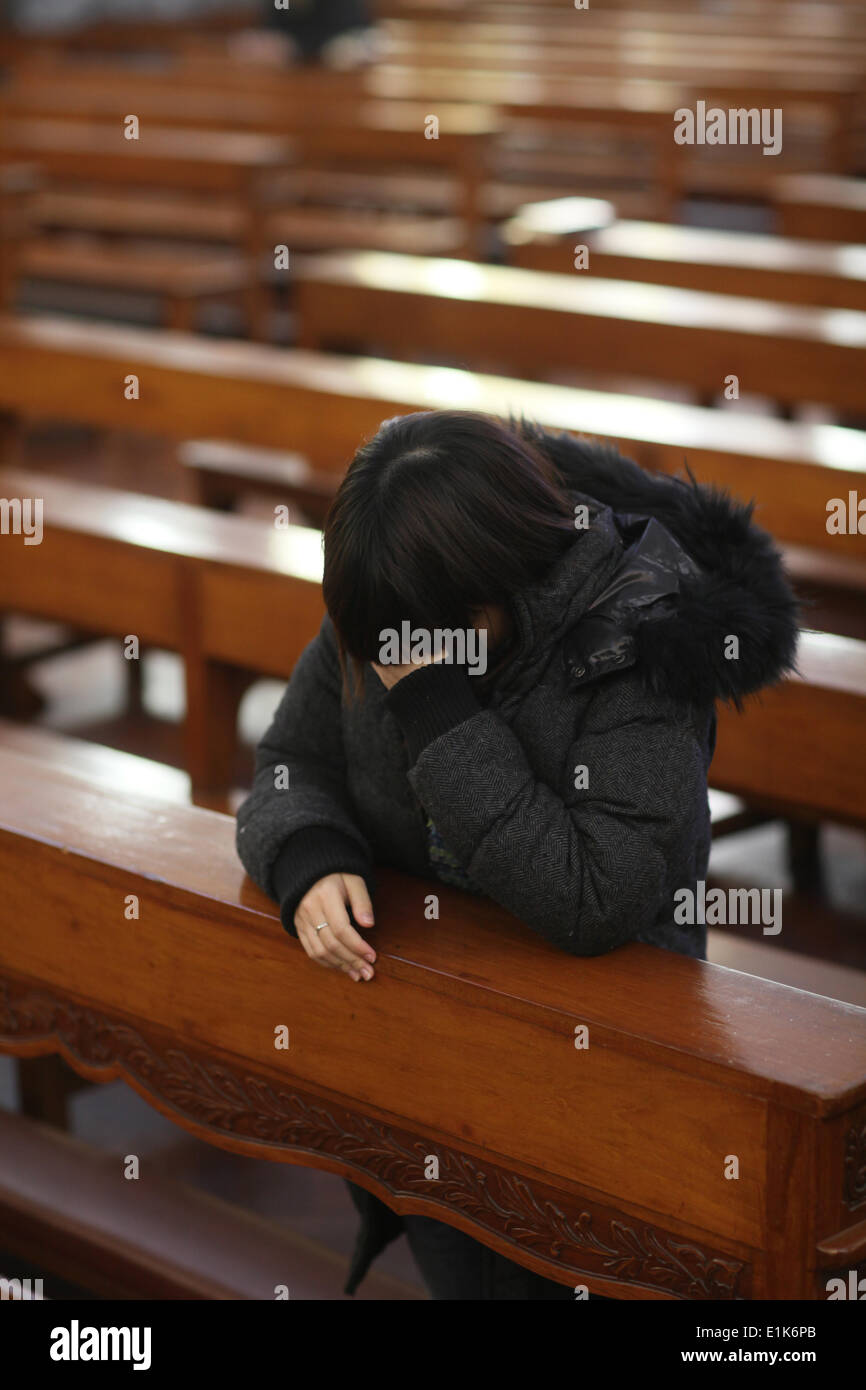 Chinese woman praying in a church Stock Photo - Alamy