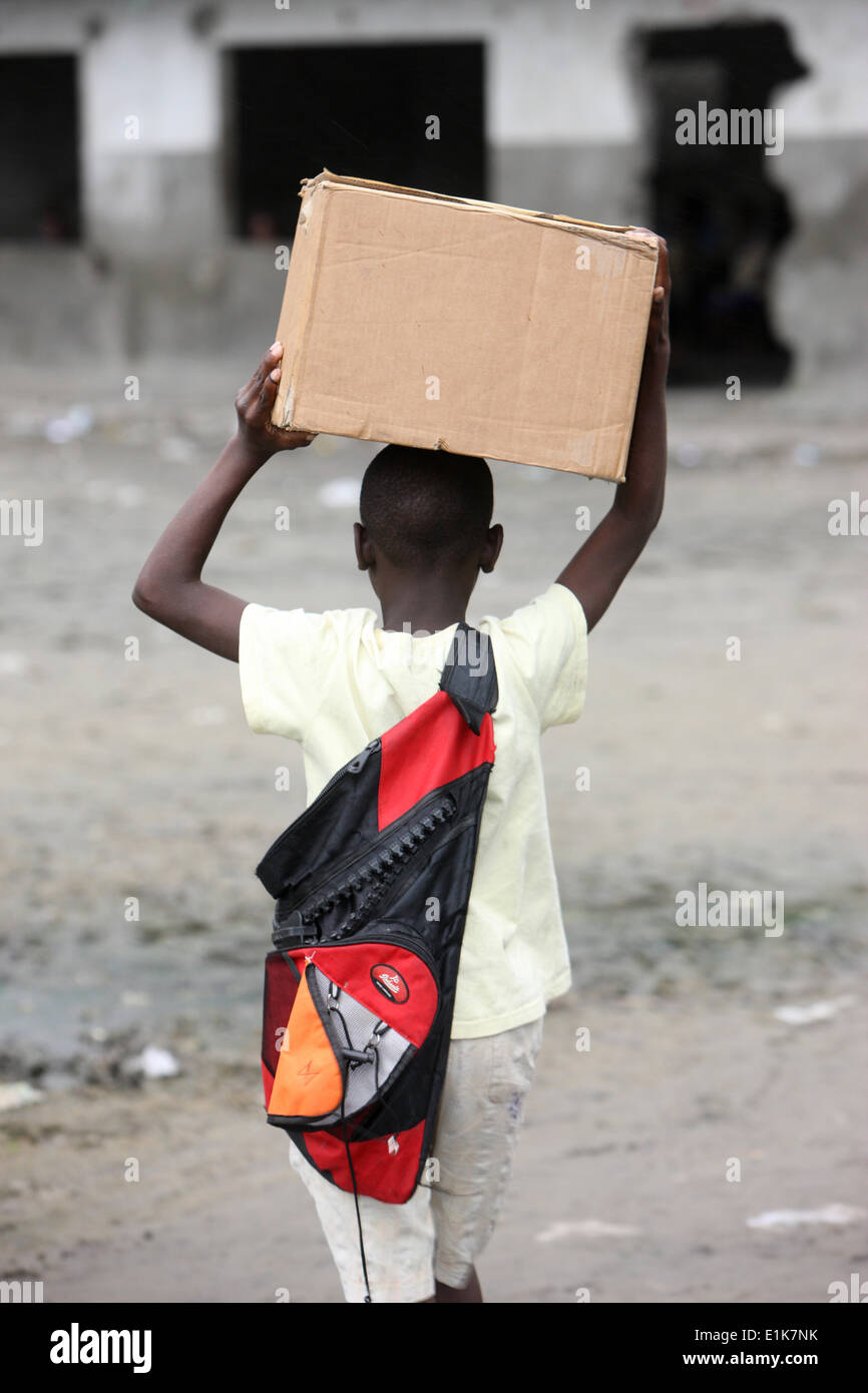 African boy carrying box hi-res stock photography and images - Alamy