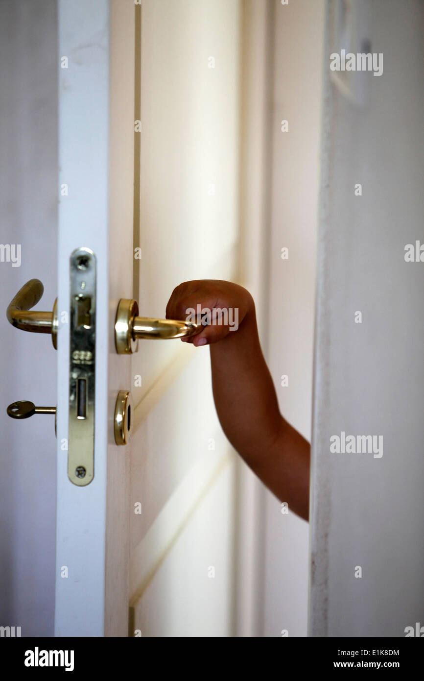 Child opening door Stock Photo - Alamy