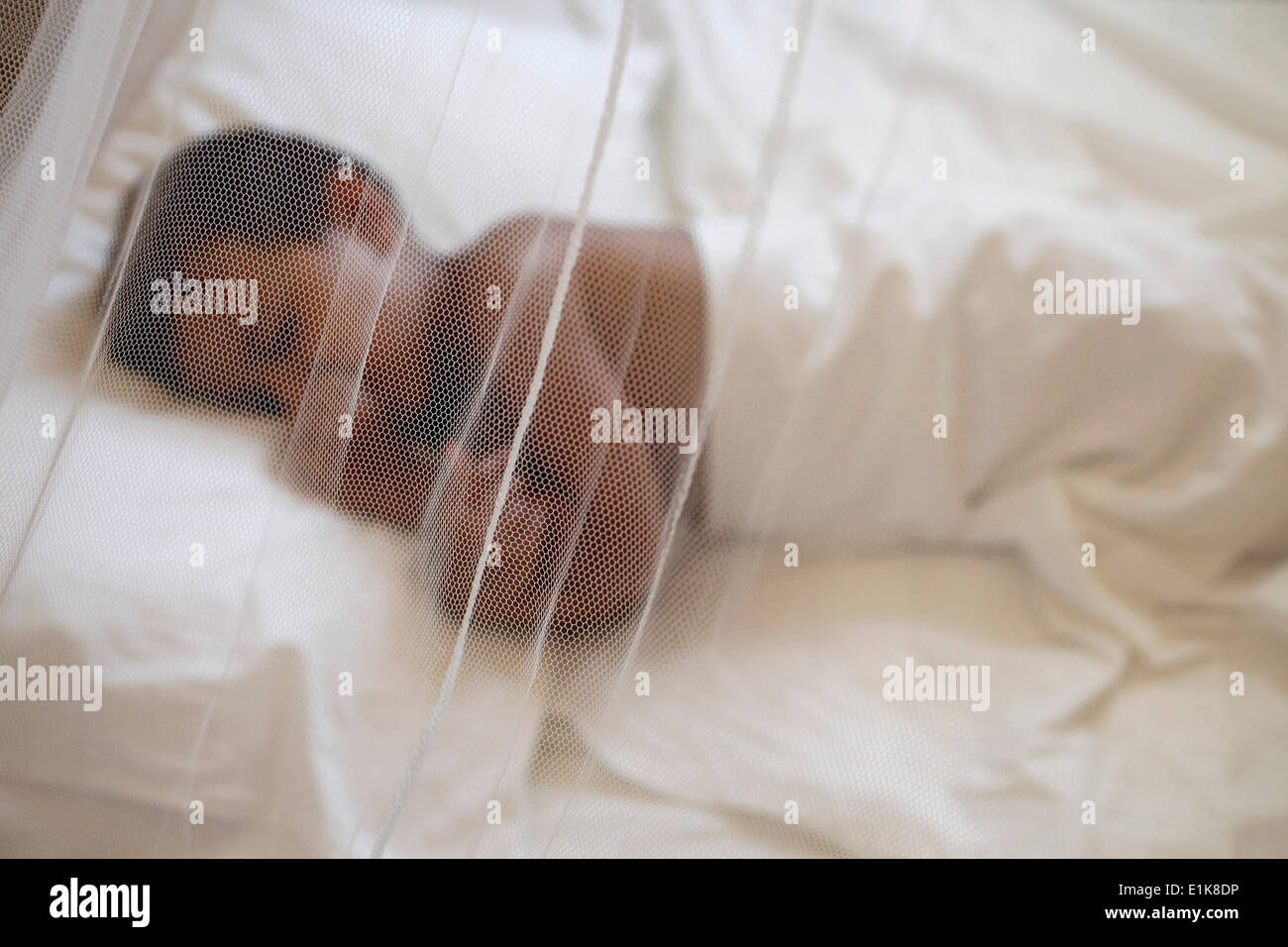 Child sleeping under mosquito net Stock Photo - Alamy
