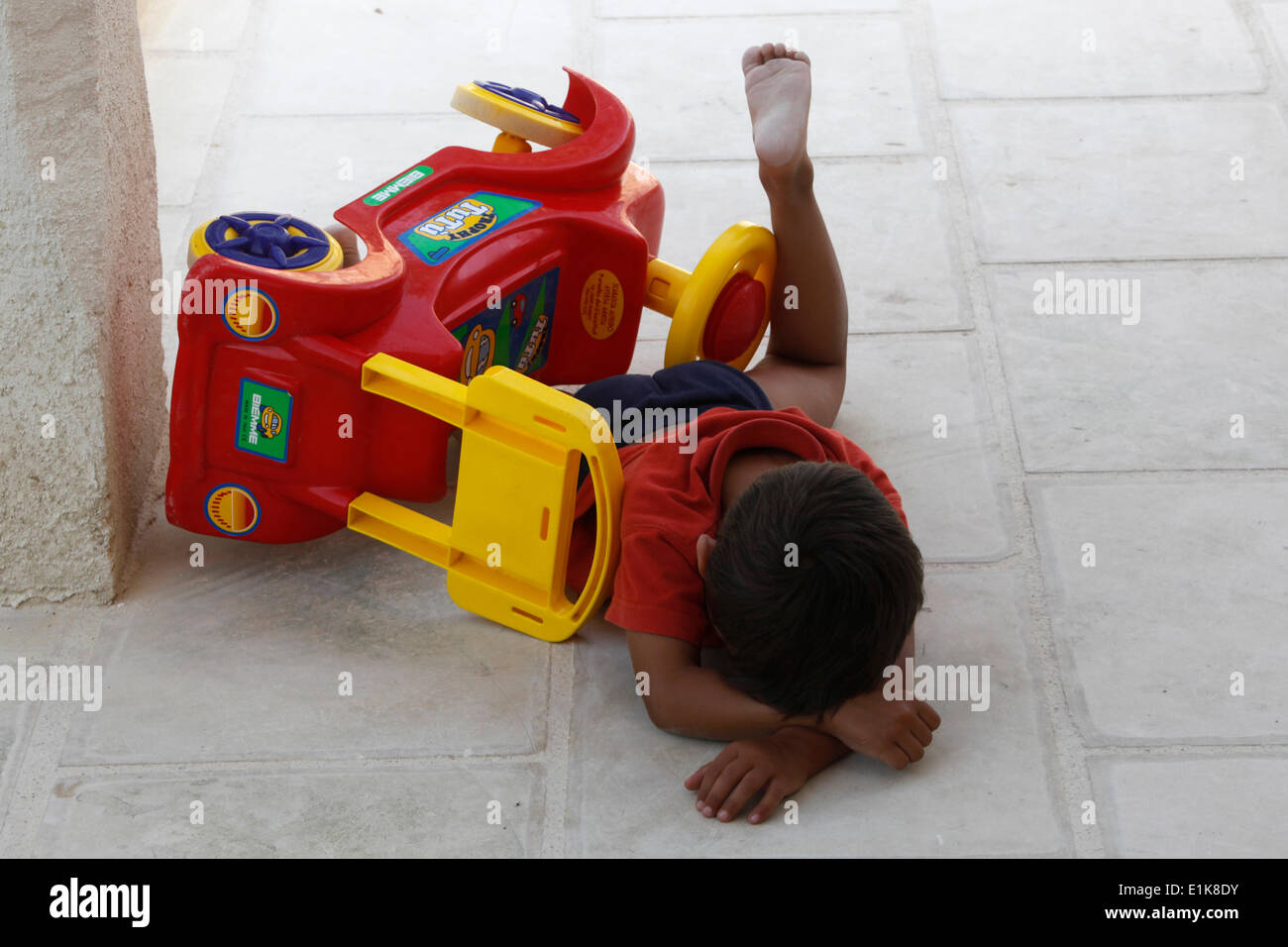 Boy falling off toy truck Stock Photo - Alamy